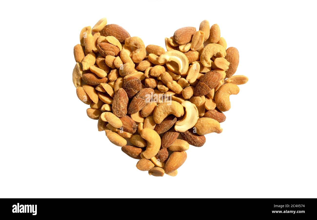 Various nuts in a heart shape isolated on white background. Top view ...