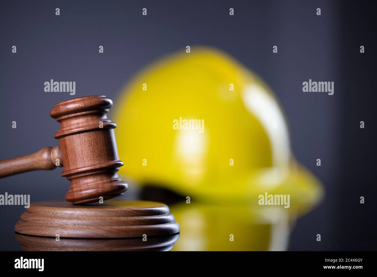 Law theme. Construction law's symbols - yellow helmet, house model and ...