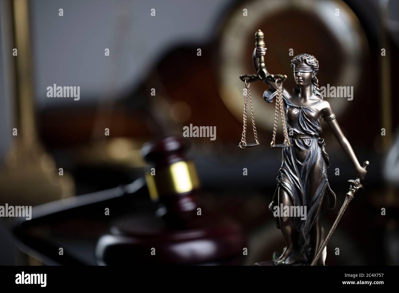 Law concept. Judge wooden gavel, scale, old clock and Themis statue on ...