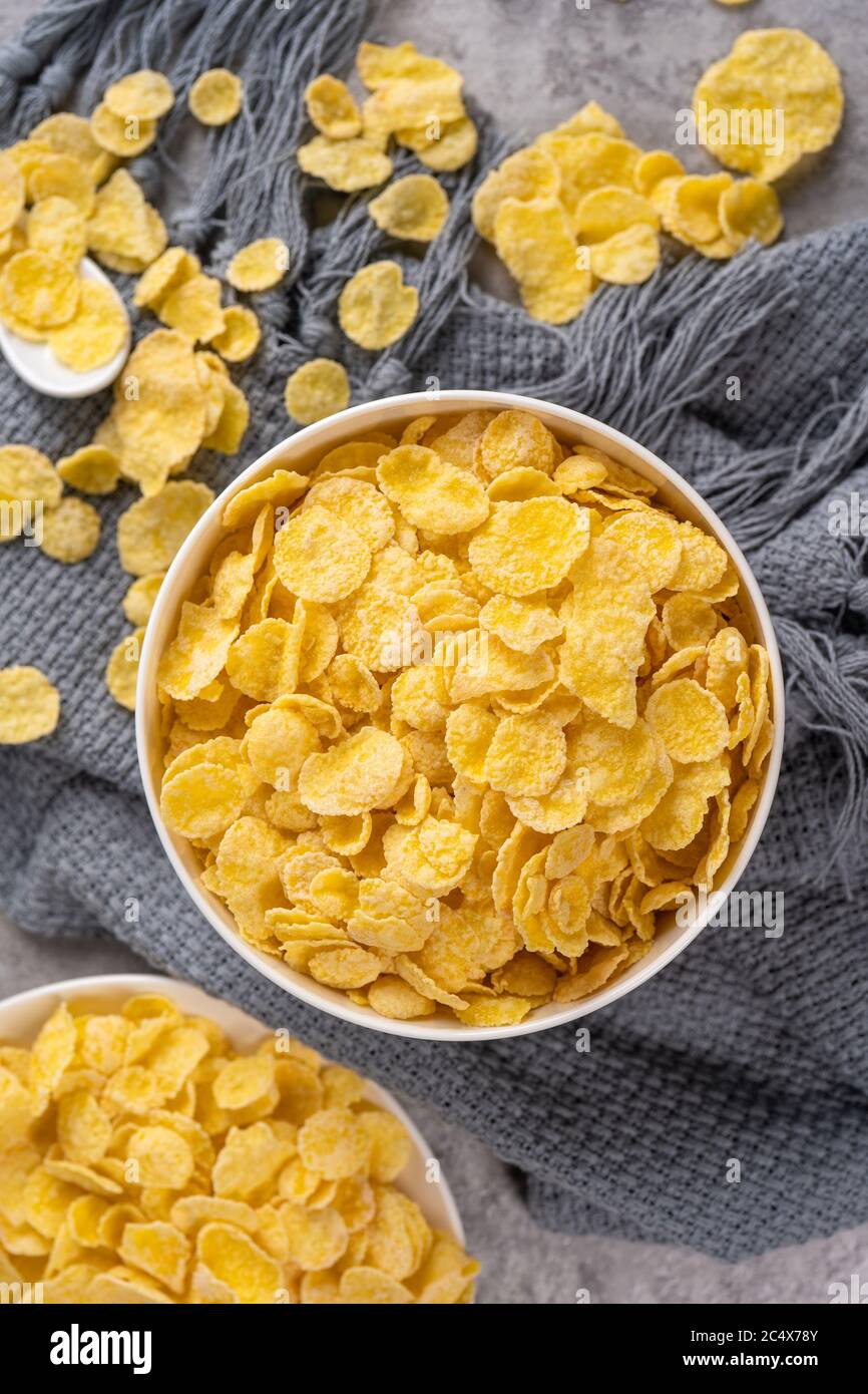 Corn flakes bowl sweets on gray cement background, top view flat lay layout design, fresh and ...