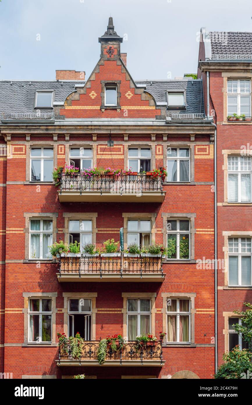 Typical brick facade of an old German apartment building with balconies ...