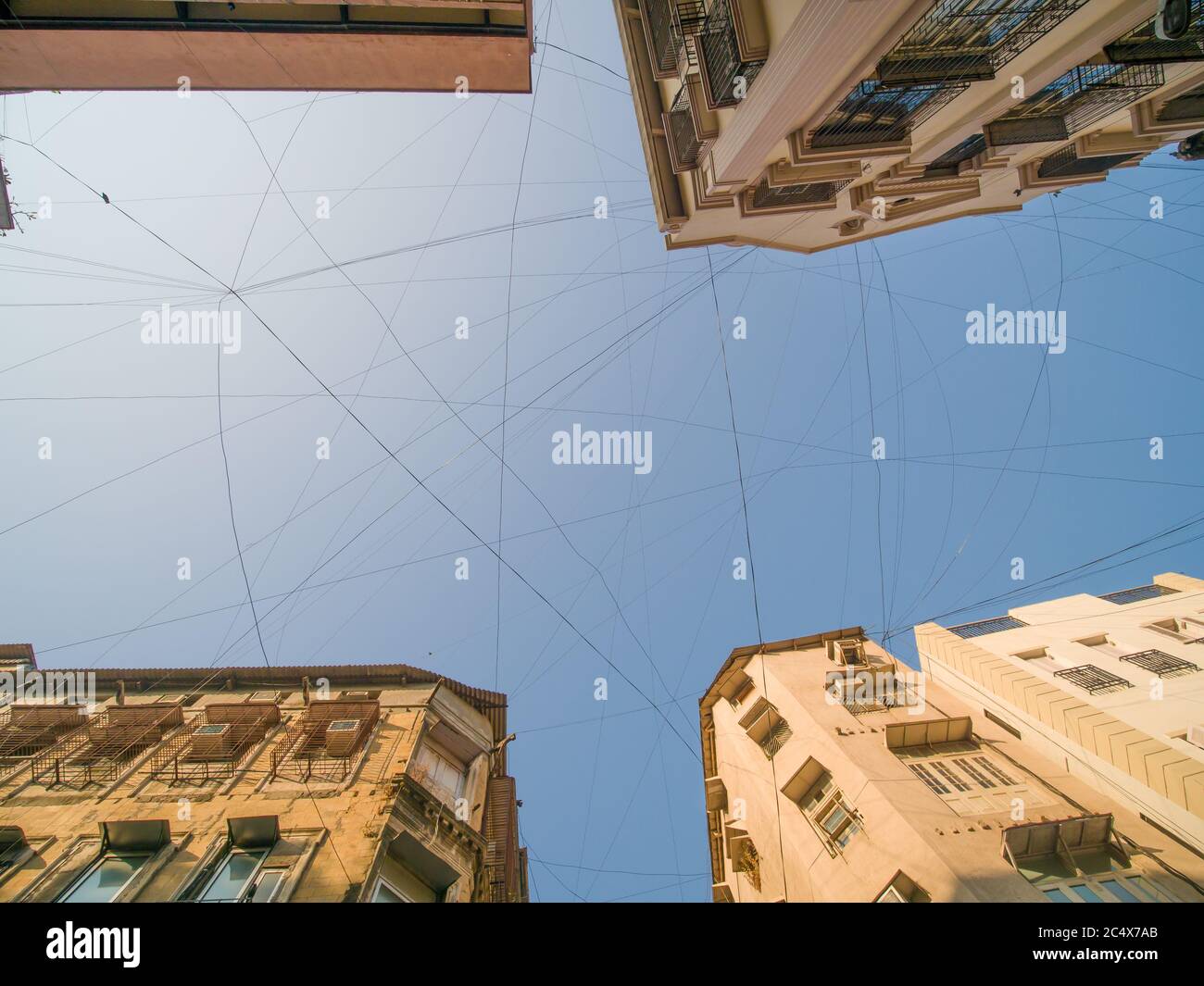 Electric wires hanging on the buildings in Mumbai Stock Photo - Alamy