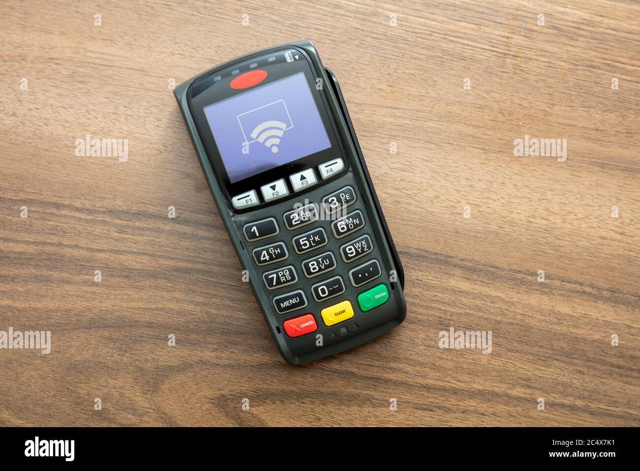 POS terminal isolated on wooden background, top view.Terminal cash ...