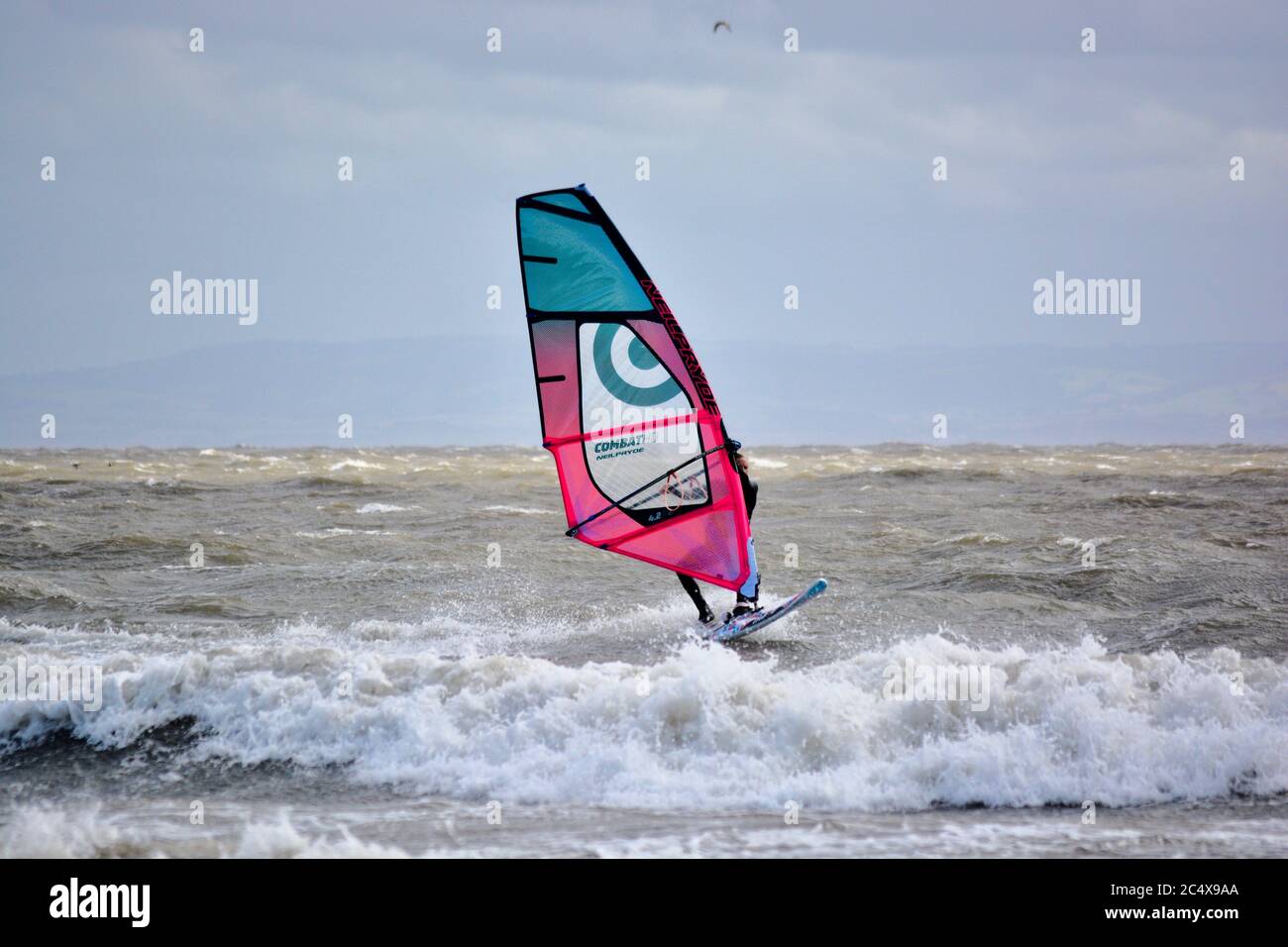 Windsurfers and Kiteboarders enjoy the surf on a stormy day in Barry ...
