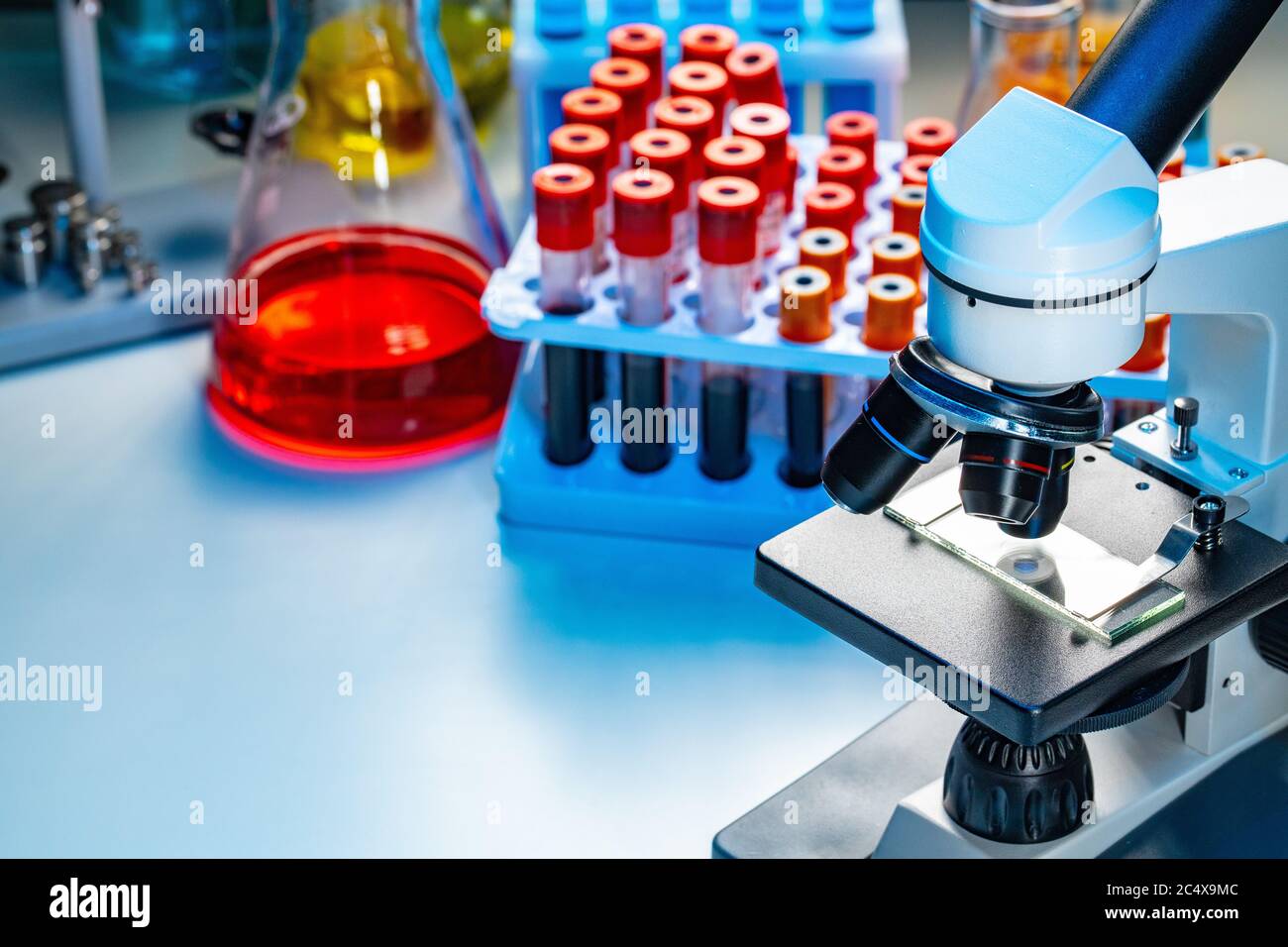 Close up photo of microscope with test tubes with blood samples Stock ...