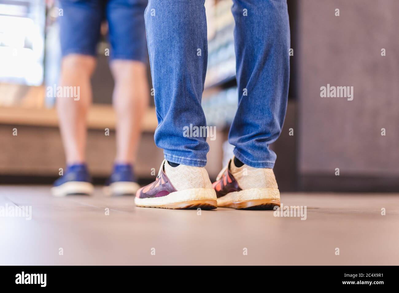 Social distancing people standing in queue in cafe Stock Photo - Alamy