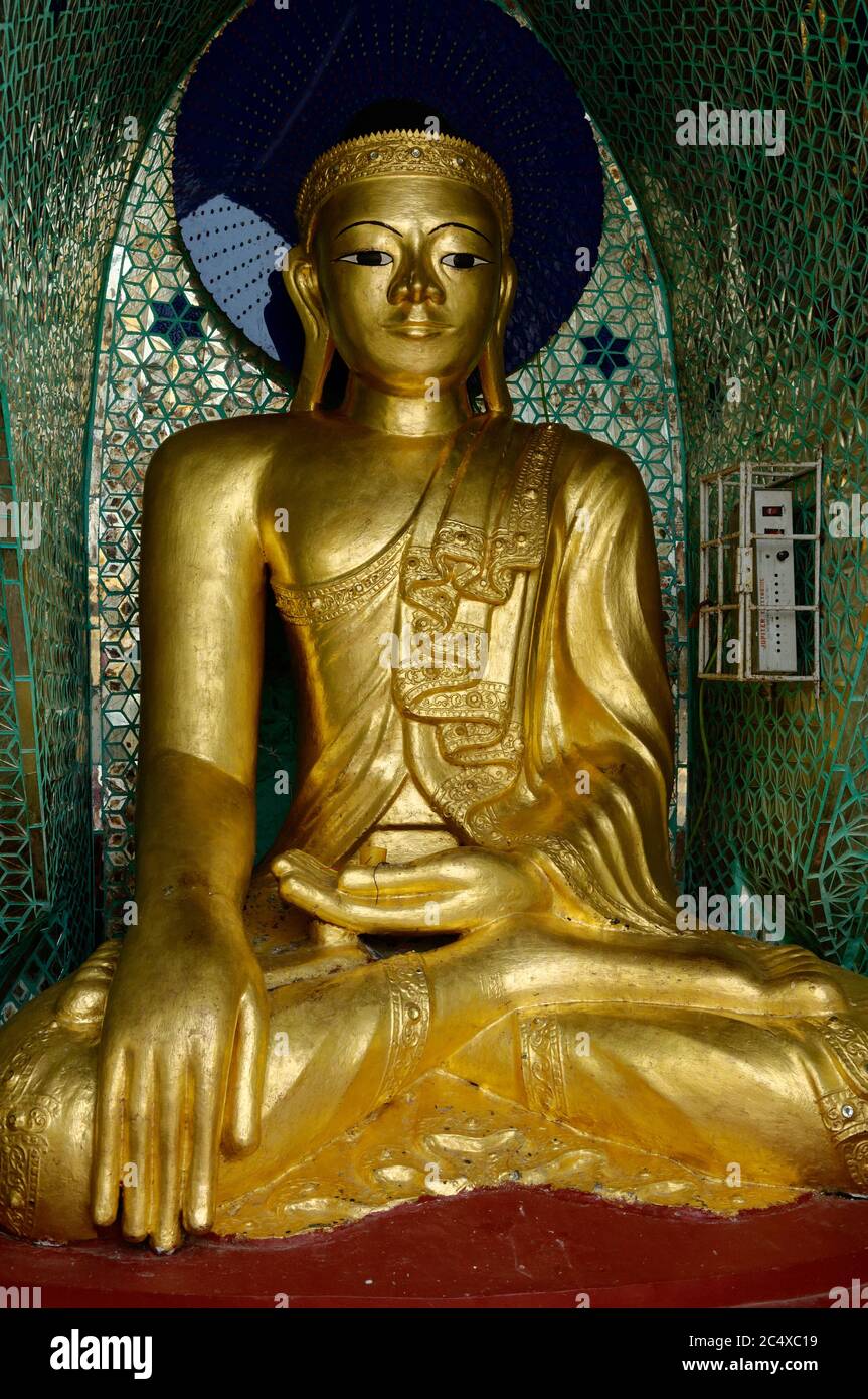 Golden Saturday Buddha with nagas in alcove shrine at the Shwedagon ...