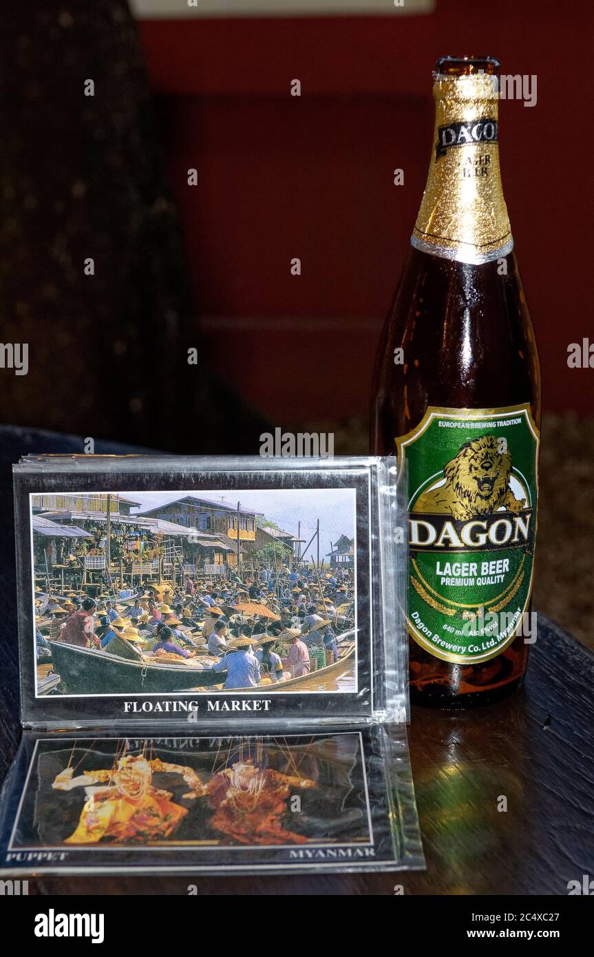 Postcards and Dagon beer bottle, travel in Myanmar, Asia Stock Photo ...