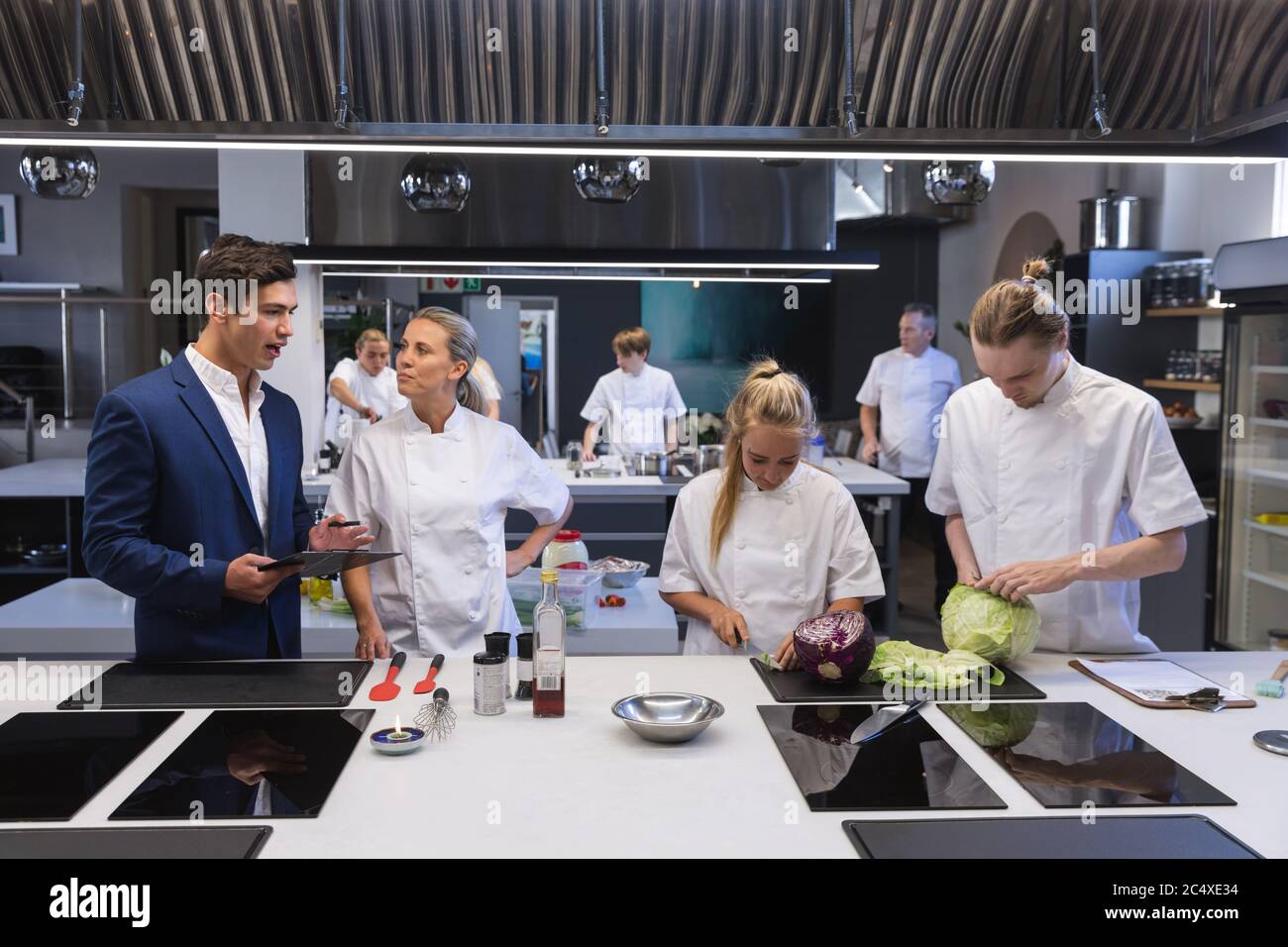 Group of chefs working at restaurant kitchen Stock Photo - Alamy