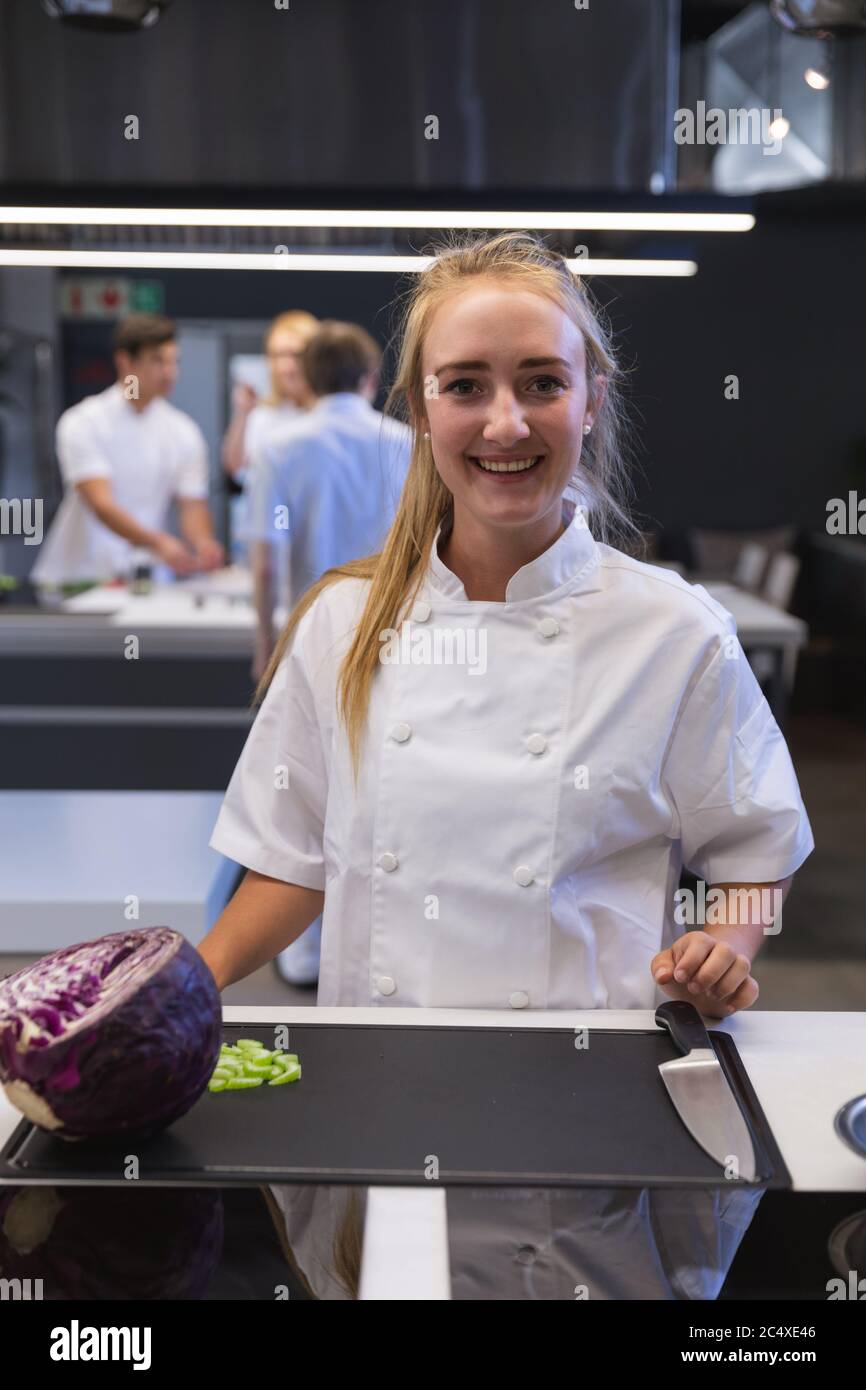 Portrait of female chef smiling at restaurant kitchen Stock Photo - Alamy