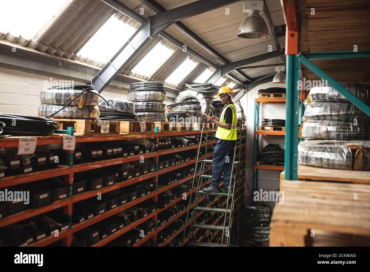 Male factory worker checking stock at the factory Stock Photo - Alamy