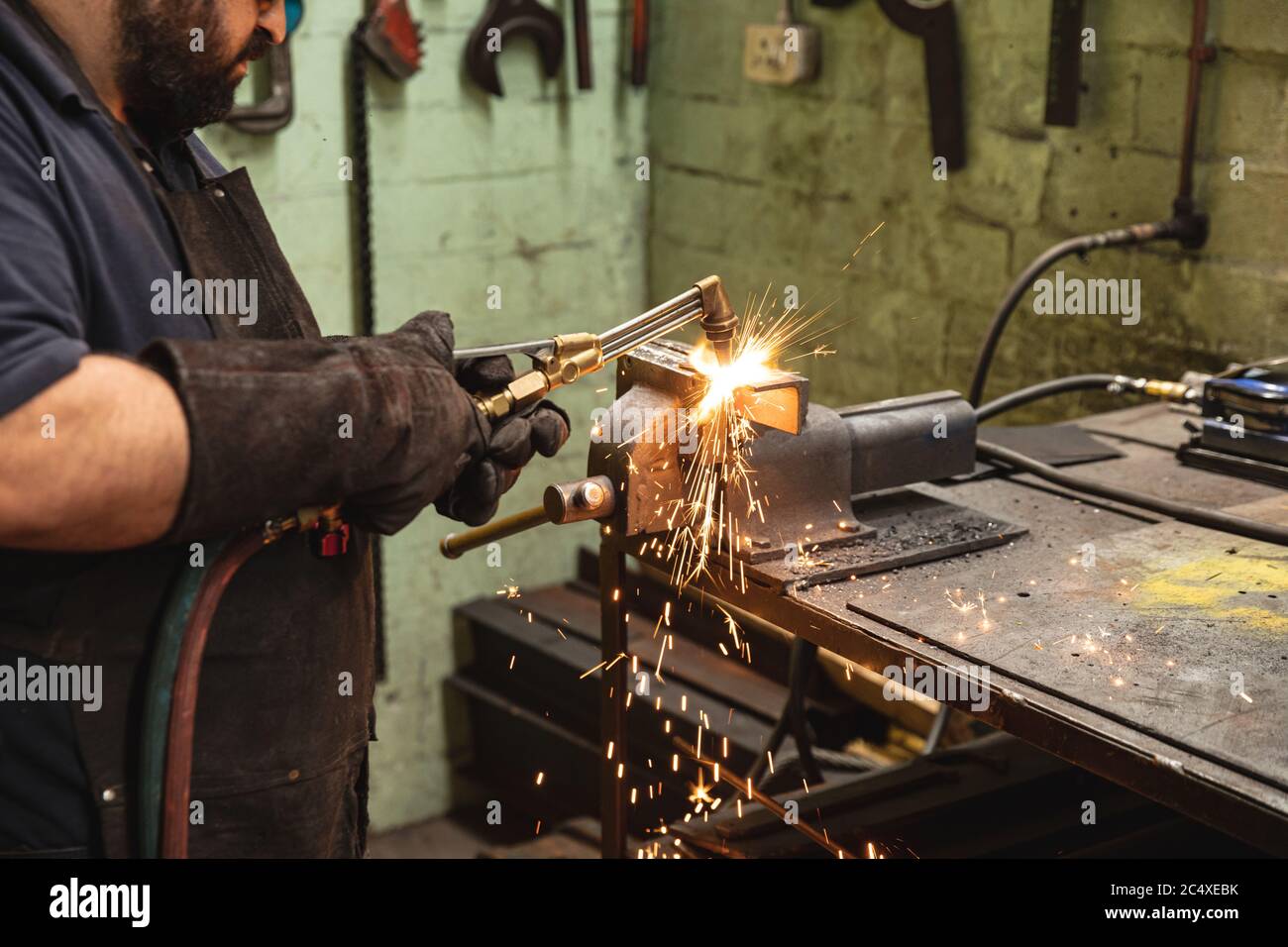 Male factory worker using welding torch at the factory Stock Photo - Alamy