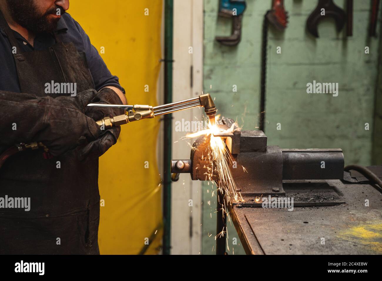Male factory worker using welding torch at the factory Stock Photo - Alamy