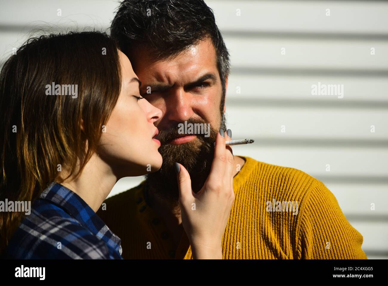 Man and woman with serious faces on white stripy background, defocused ...