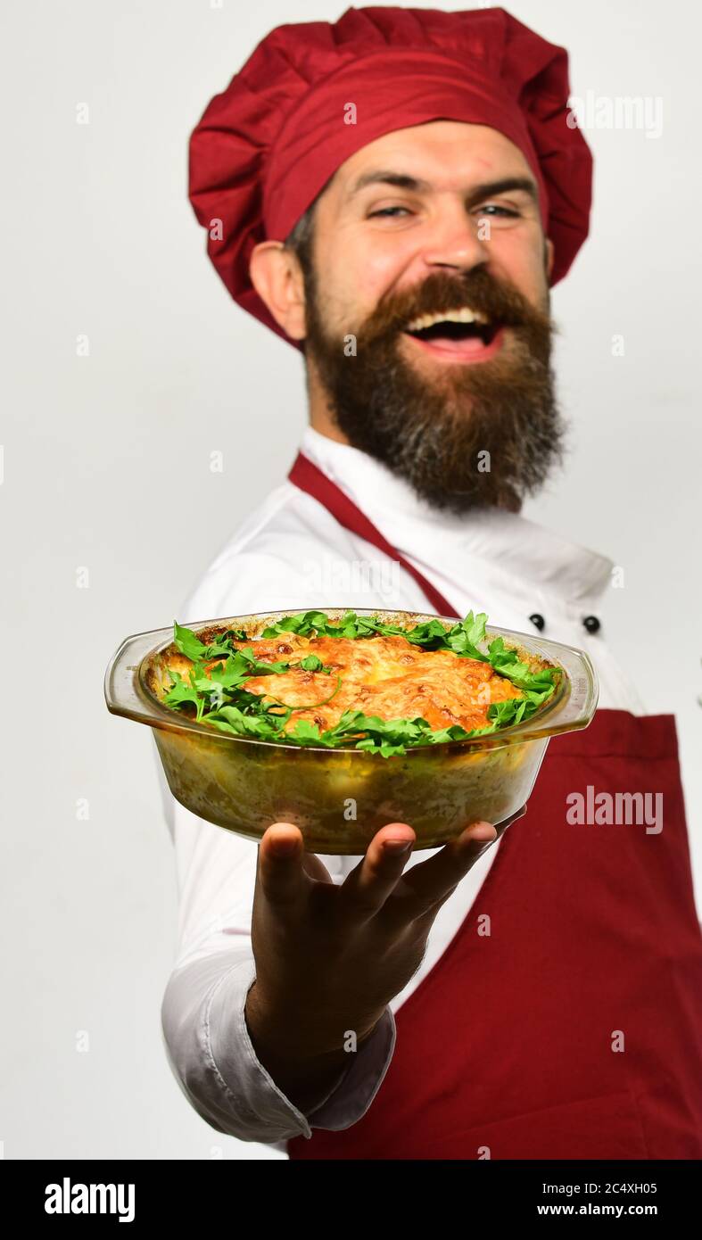 Man with beard isolated on white background. Chef holds bowl with ...