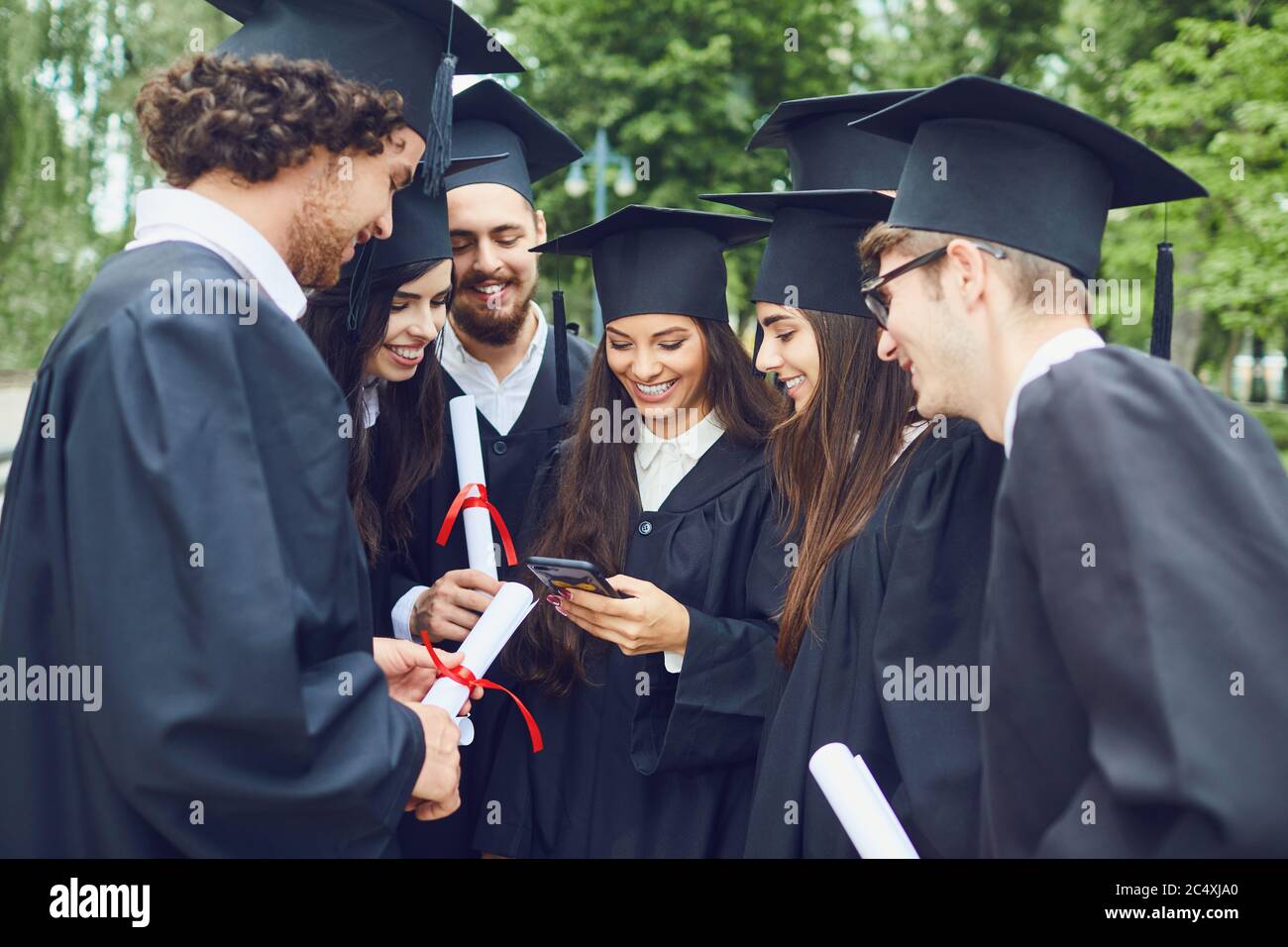 A group of graduates smiling Stock Photo - Alamy