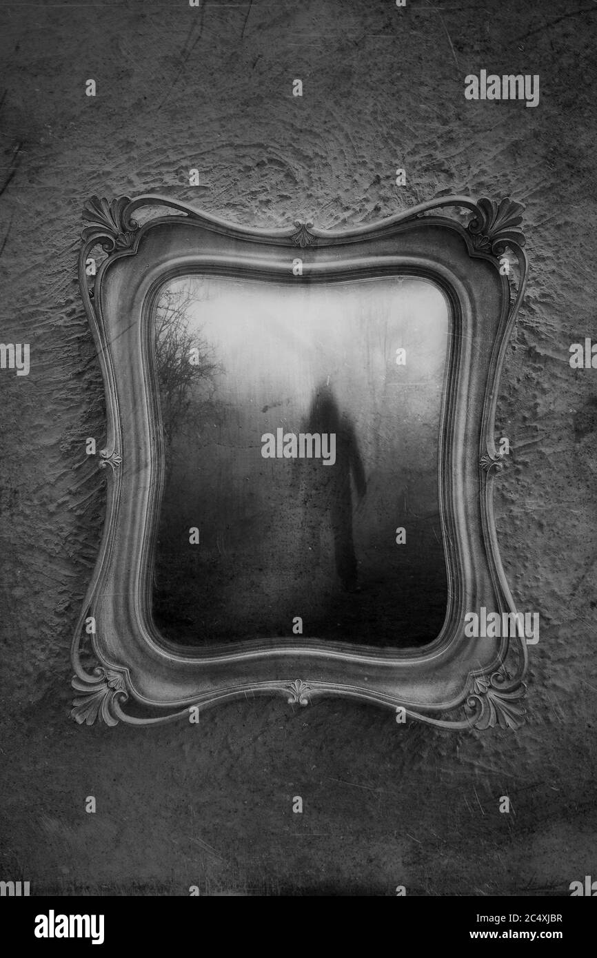 Horror concept of a ghostly figure in a mirror. With a grunge, blurred ...