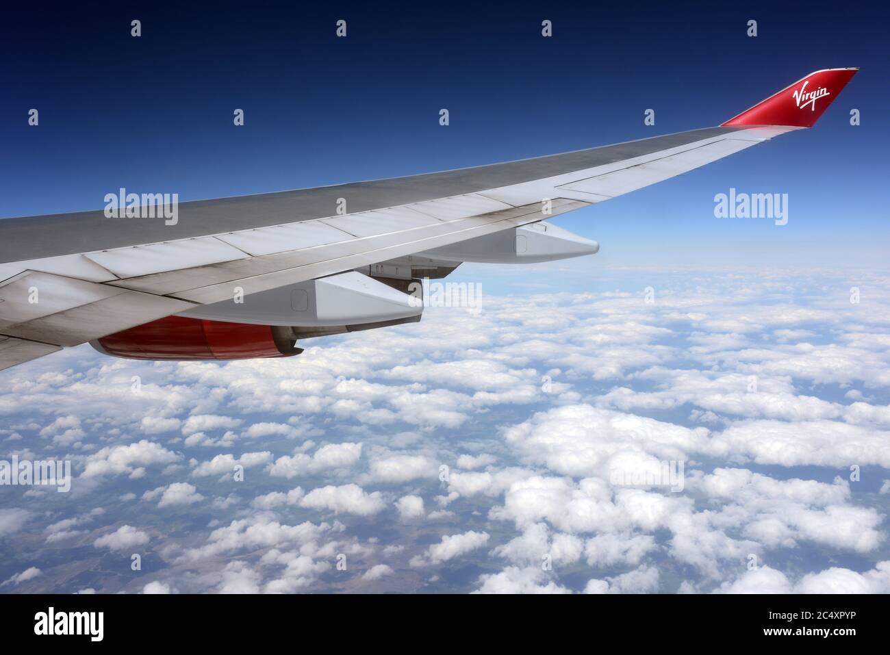 Starboard wing of a Virgin Atlantic 747 in flight over Wales above ...