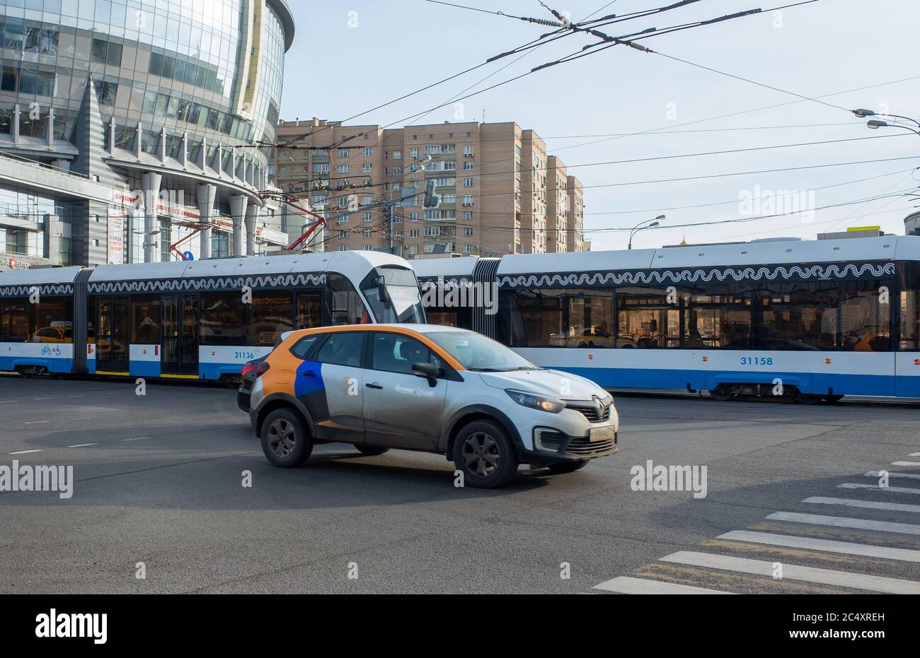 March 18, 2019, Moscow, Russia. A Yandex Drive car and a tram on a busy ...
