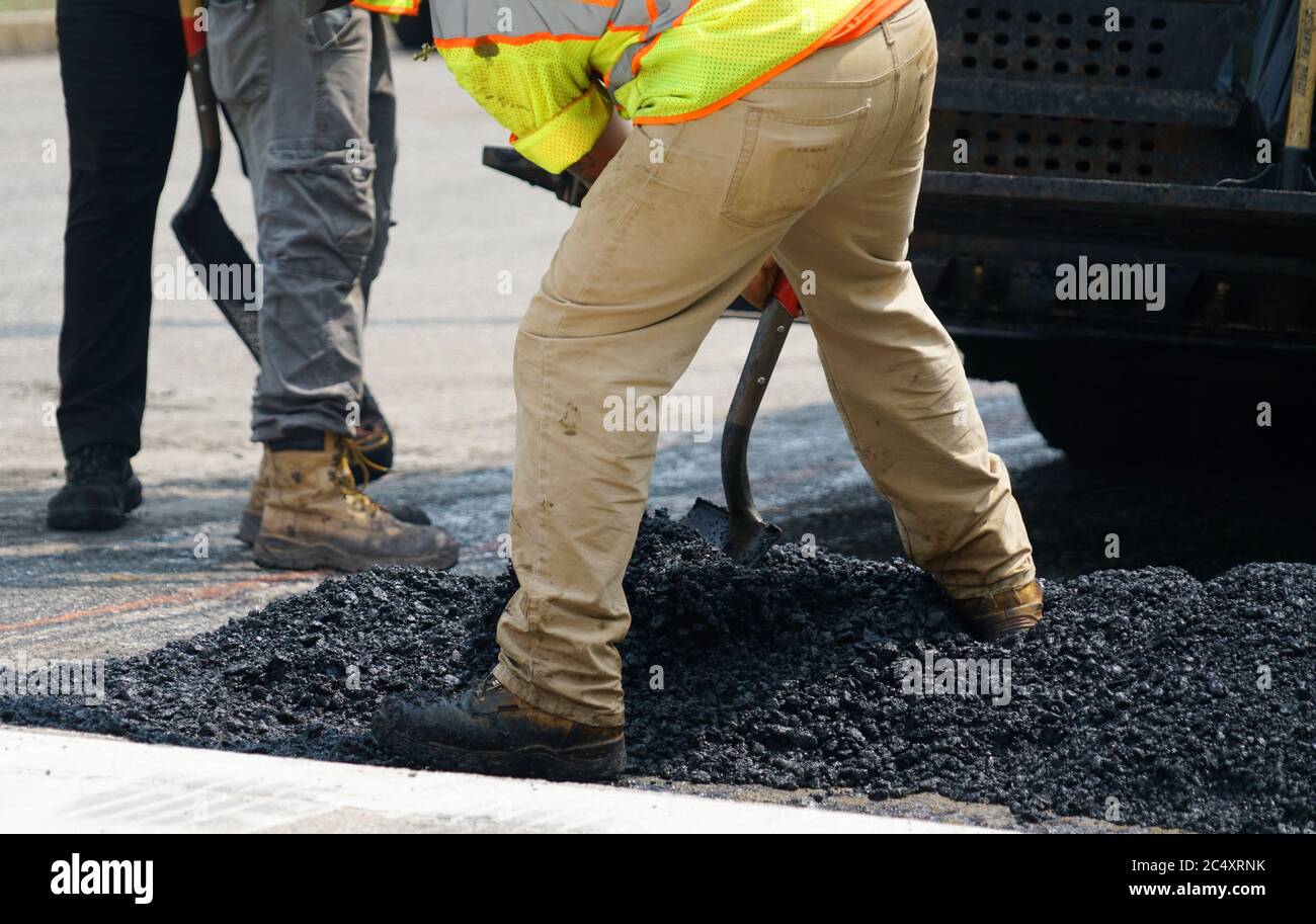 worker paving the road with asphalt Stock Photo - Alamy