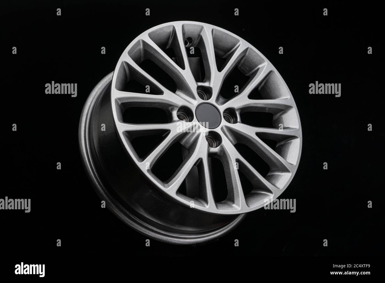 multi-spoke gray alloy wheel on black background Stock Photo - Alamy