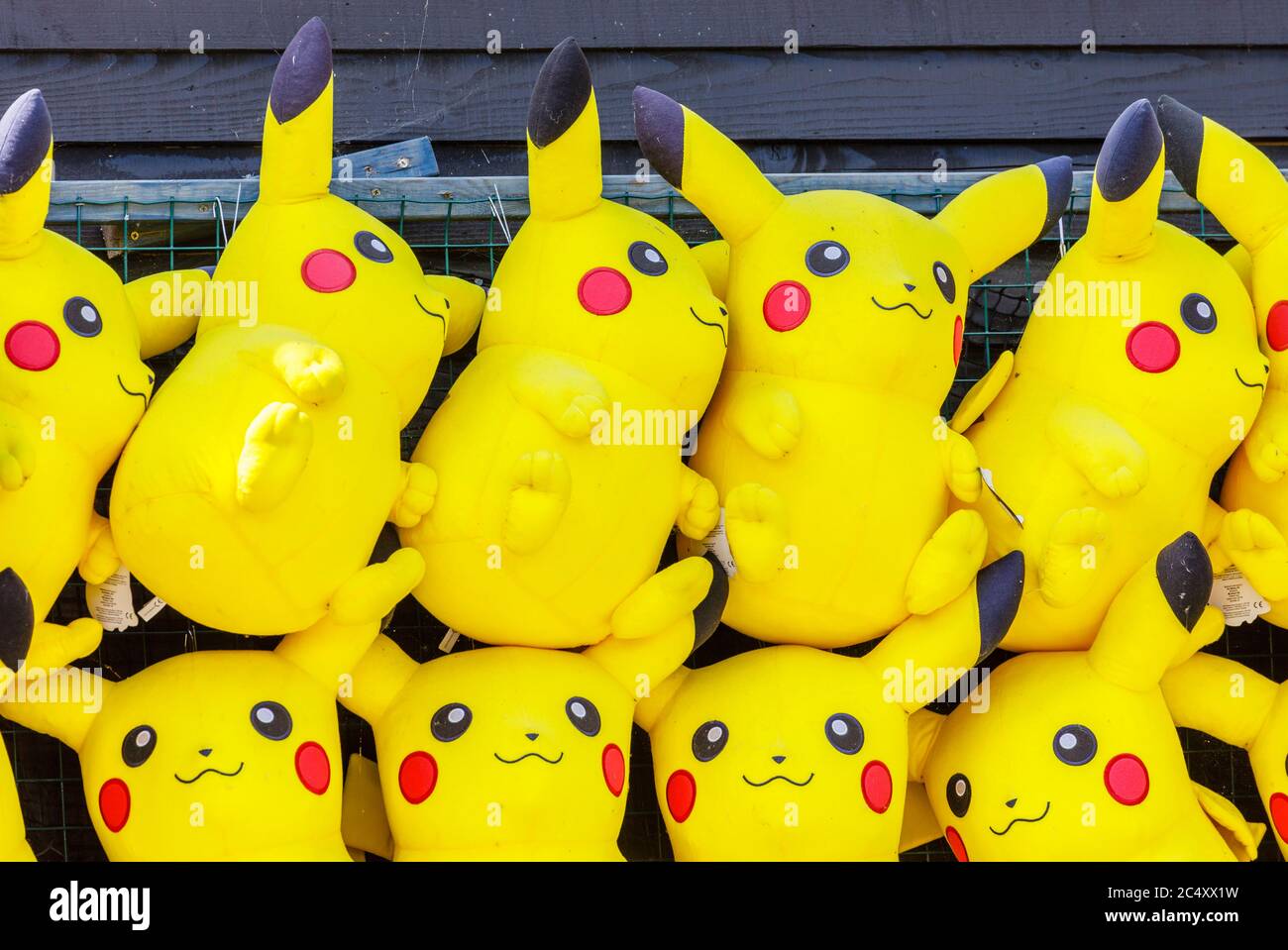 Yellow Pikachu Pokemon toys, fairground stall prizes hanging up in ...