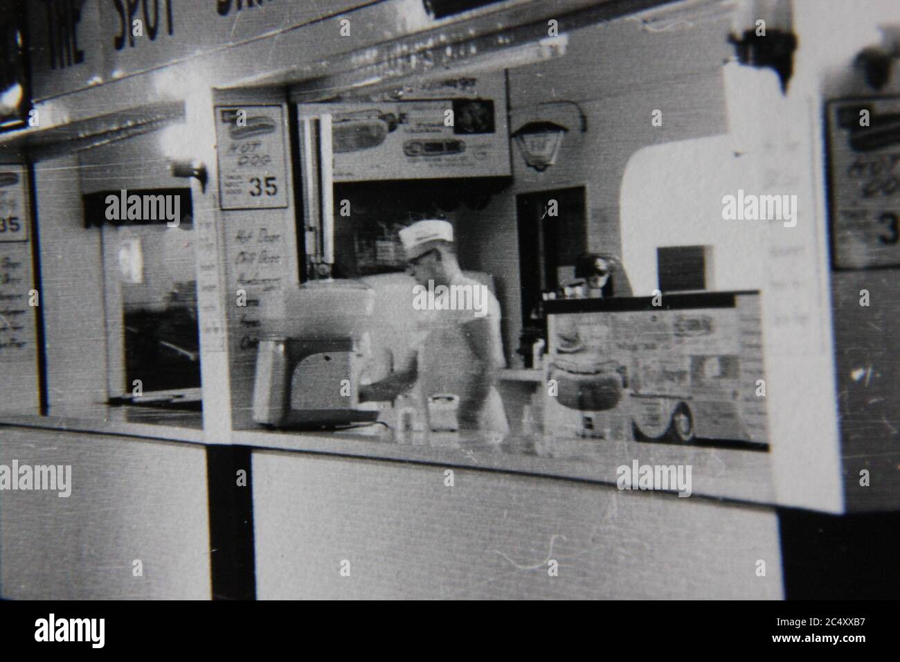 Fine 70s vintage black and white photography of a cook manning a fast ...