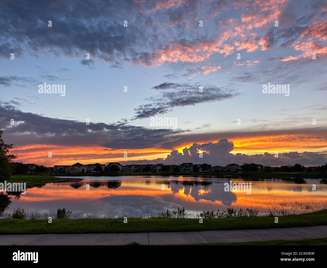 Beautiful pink, orange and blue sunset reflecting on a lake in a ...