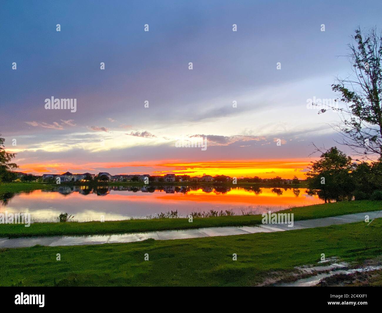 Beautiful pink, orange and blue sunset reflecting on a lake in a ...