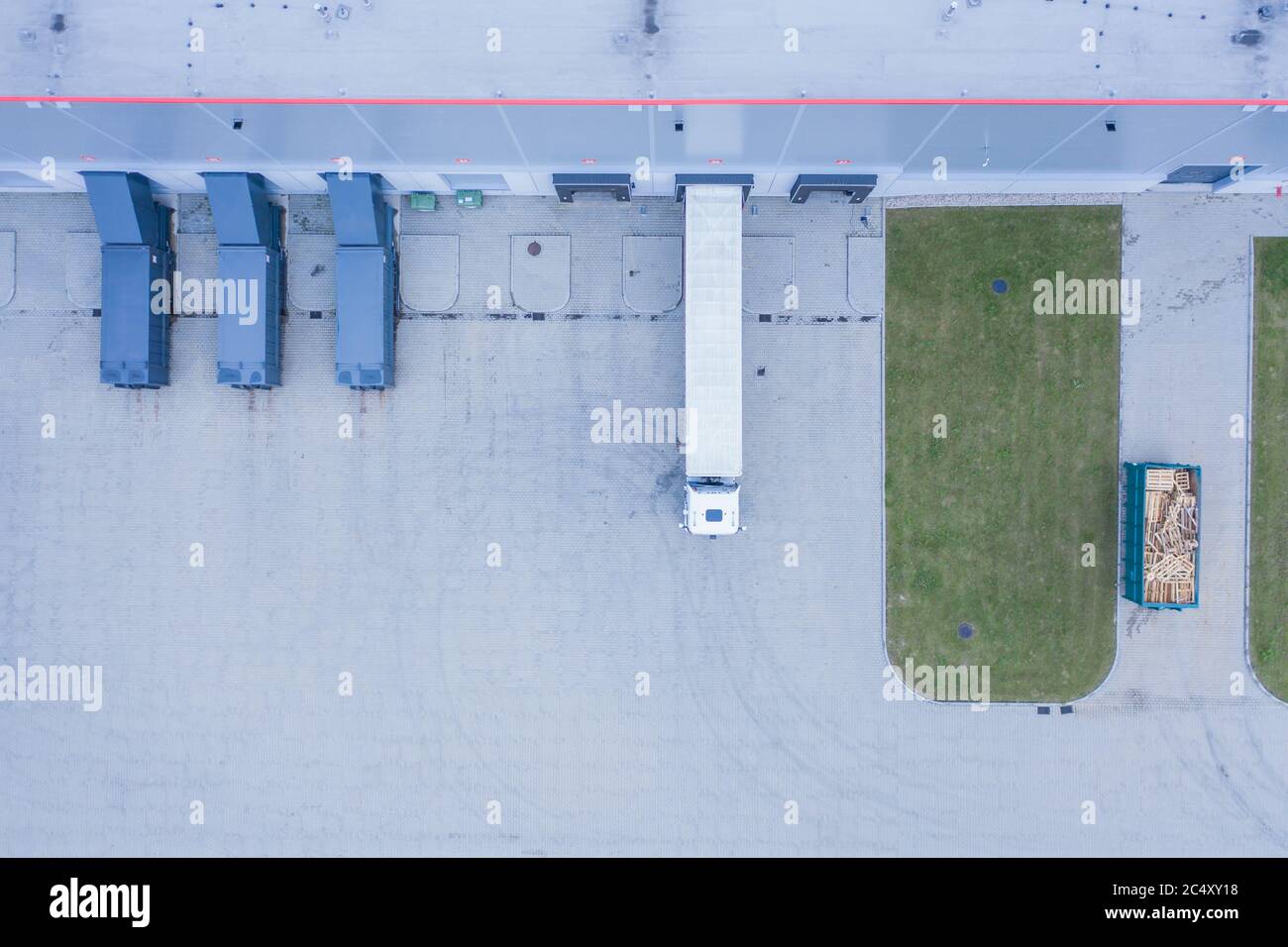 Aerial view of trucks unloading in logostics center. Logistics center ...