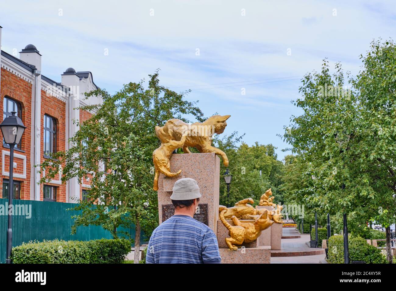 Tourist walking through the square of Siberian cats in Tyumen. Russia ...