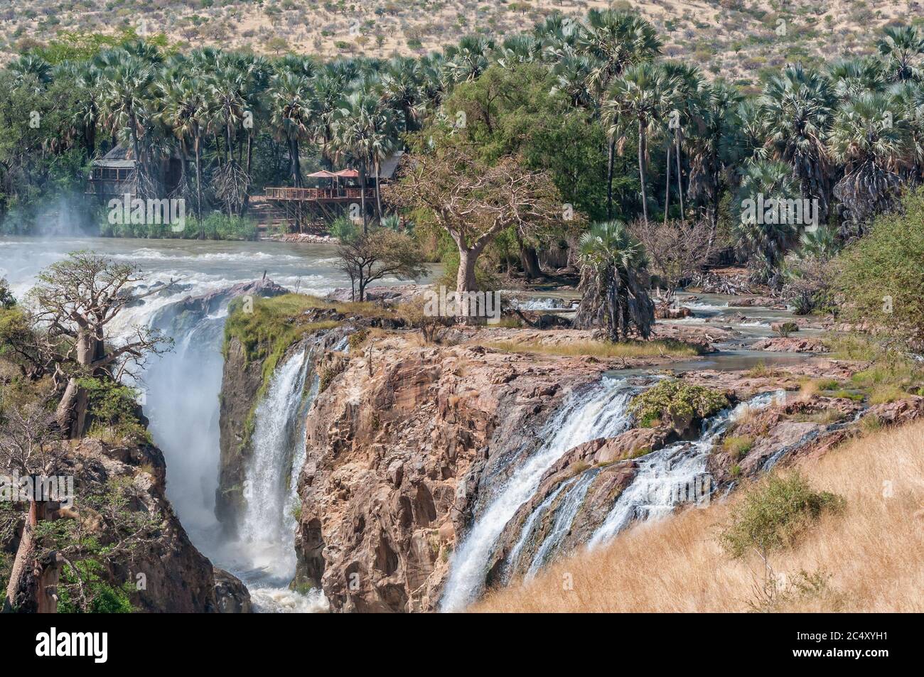 Part of the Epupa waterfalls in the Kunene River. Buildings, baobab and ...