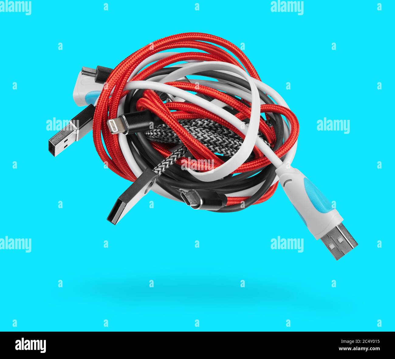 Tangled roll of computer wires over blue background Stock Photo - Alamy