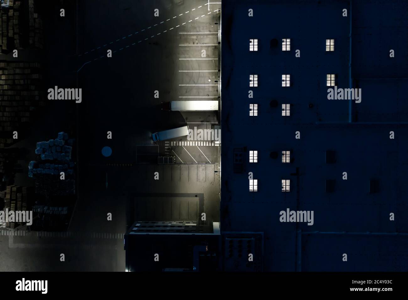 Night Aerial view of trucks unloading in logostics center. Logistics ...