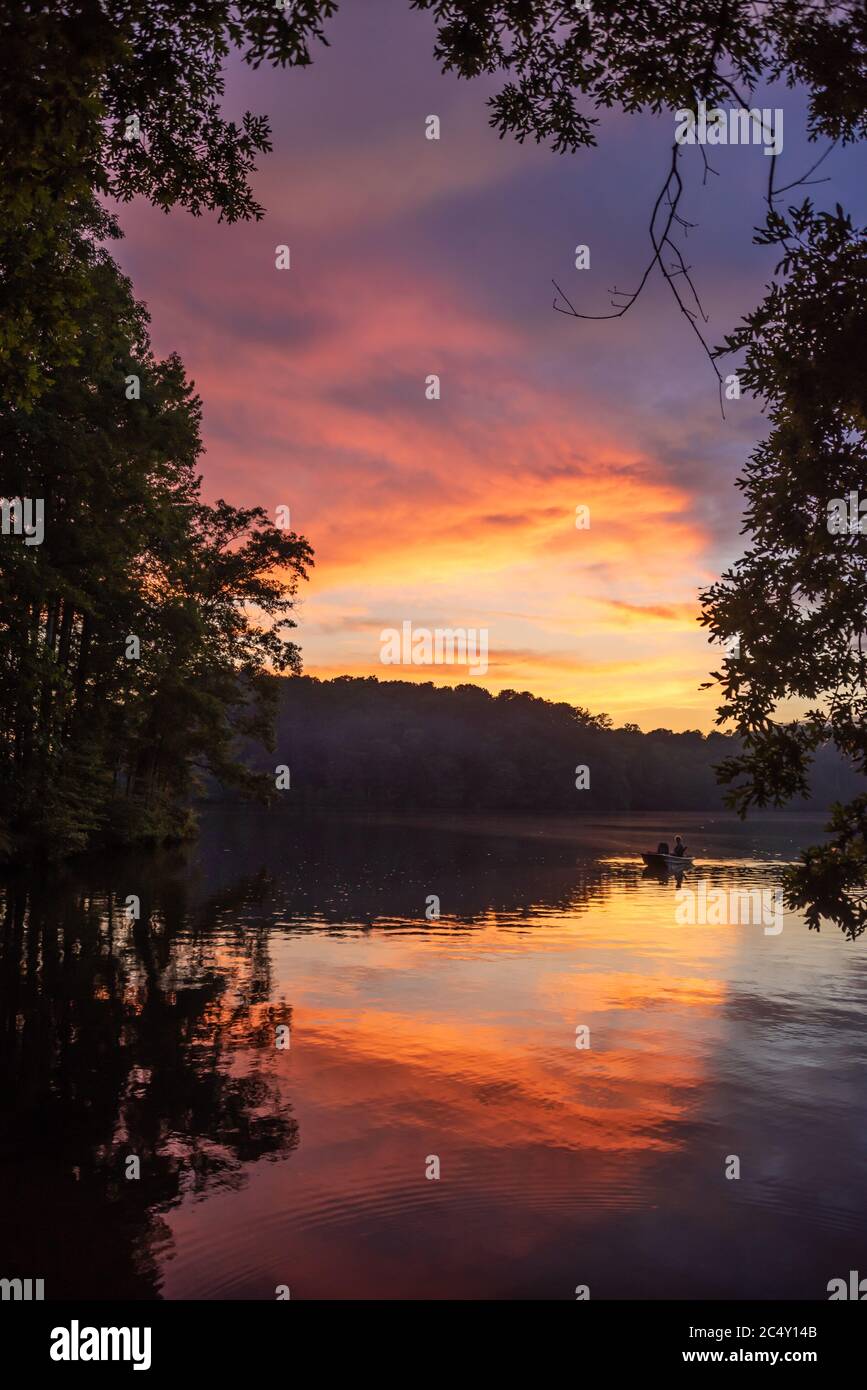 Boater enjoying a colorful sunset at Fort Yargo State Park in Winder ...
