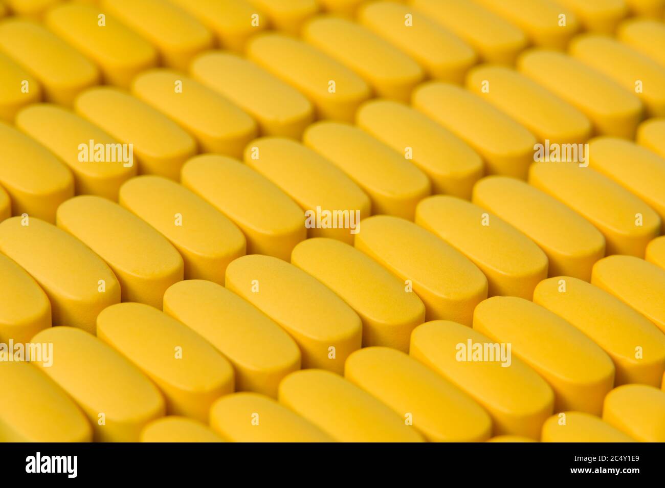 long line of yellow medical drug on pharmaceutical produce Stock Photo ...