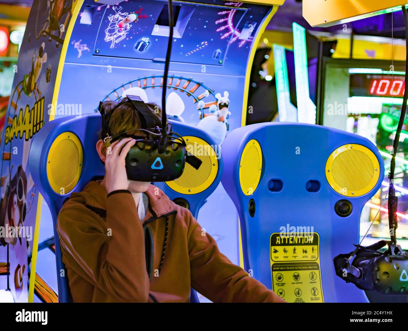 Kid while playing virtual reality game in an arcade game center Stock ...