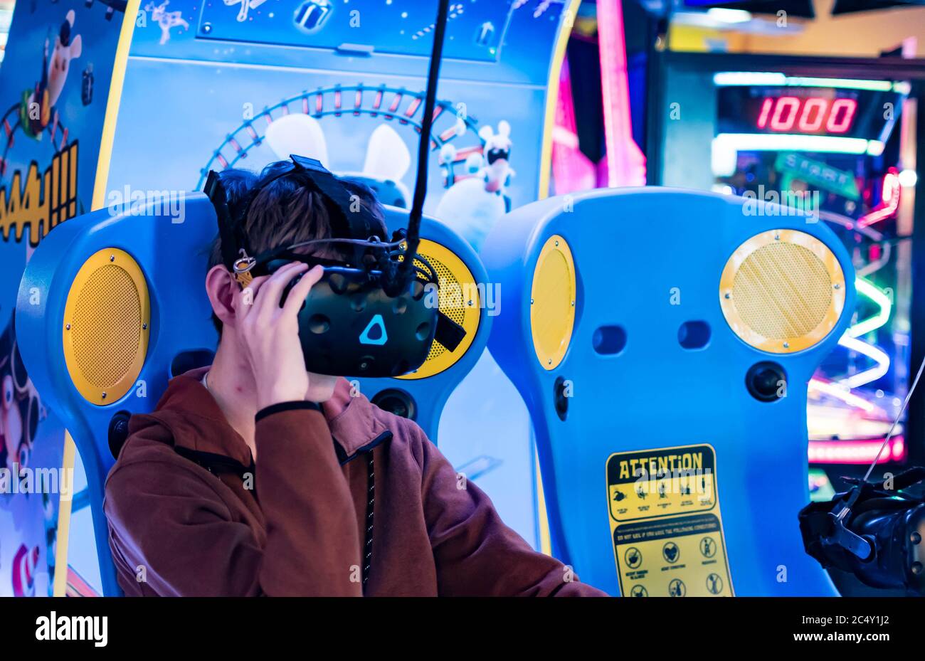 Kid while playing virtual reality game in an arcade game center Stock ...