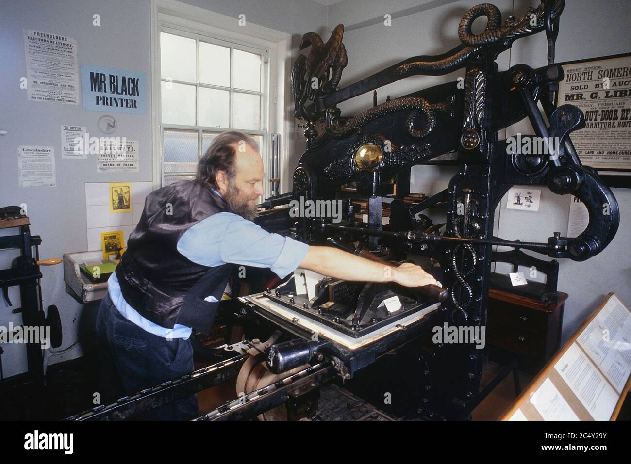A printer using the Columbian press at the Museum of Lincolnshire Life ...