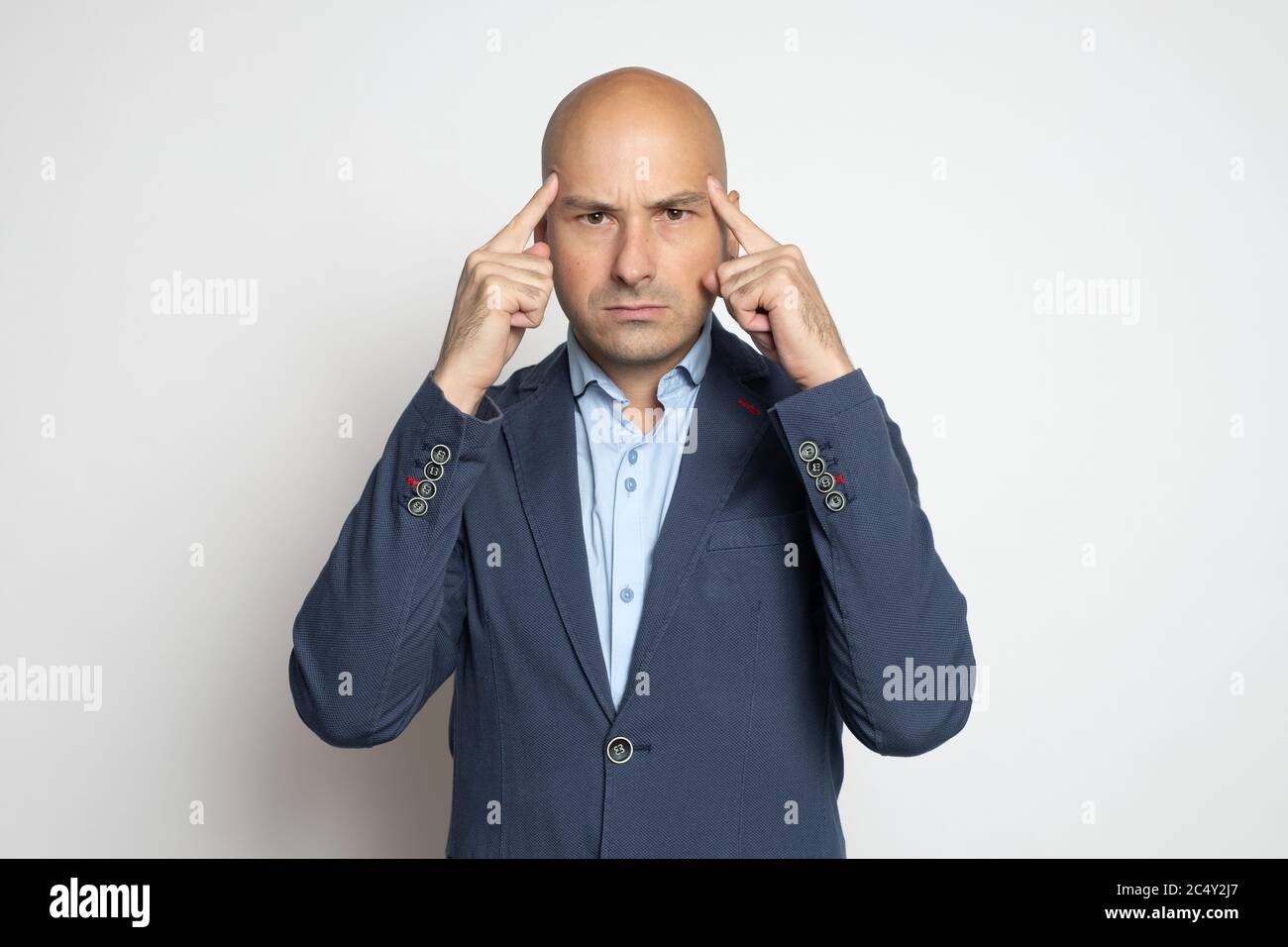 Serious bald man in blue jacket is thinking hard about problems Stock ...