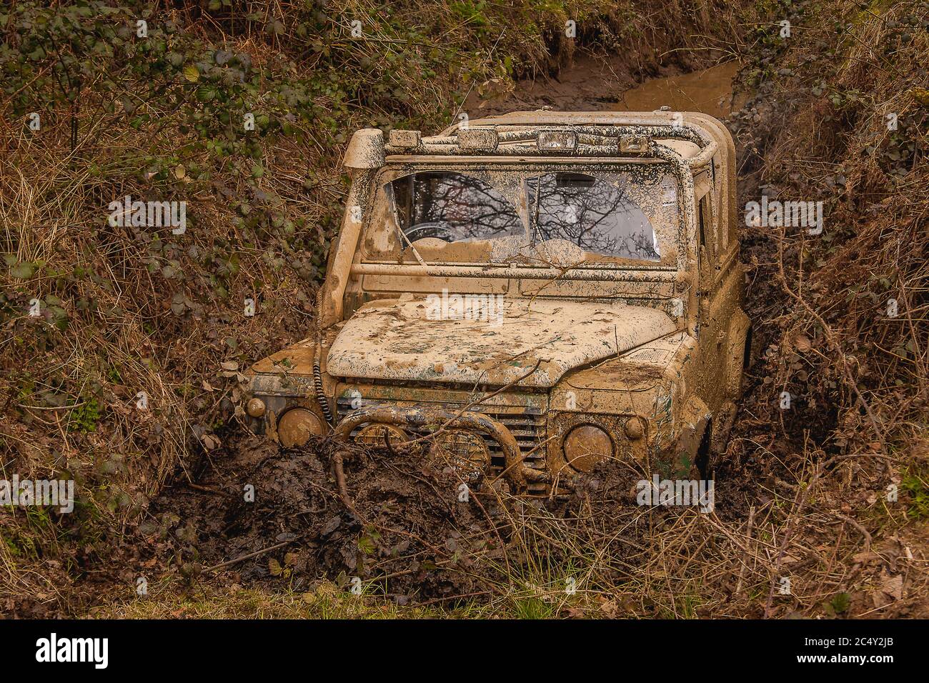 land rovers in full off road mode form winching up a steep bank to ...