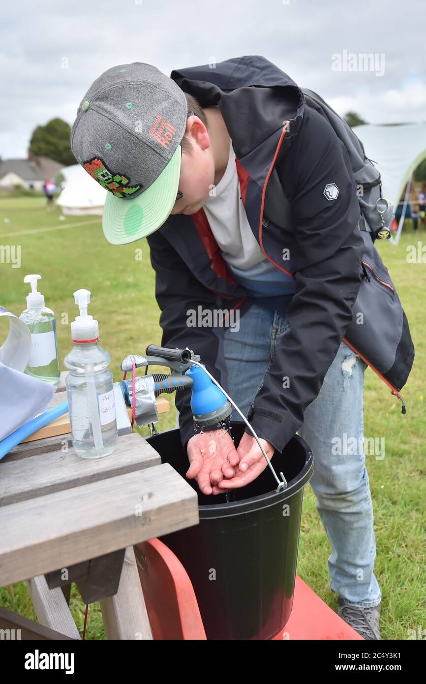 Year six pupils wash their hands at a temporary wash and sanitising ...