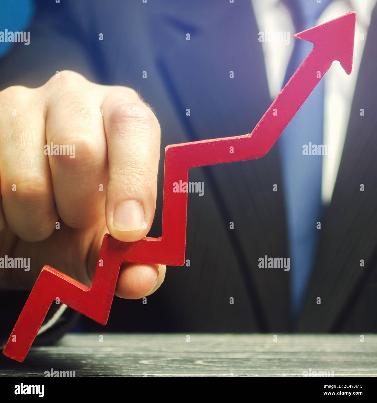 Businessman holds up arrow. Concept of successful development of ...