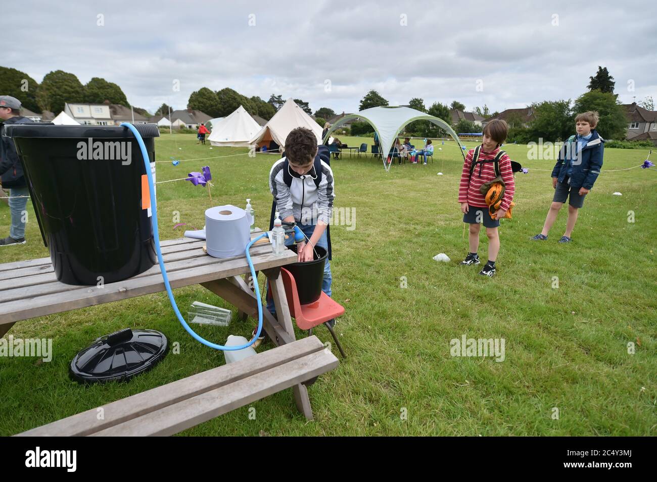 Year six pupils wash their hands at a temporary wash and sanitising ...