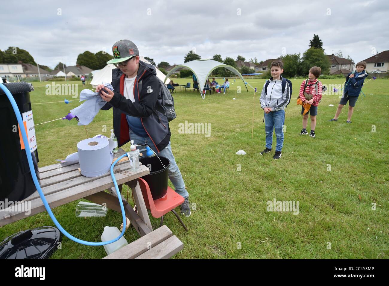 Year six pupils wash their hands at a temporary wash and sanitising ...