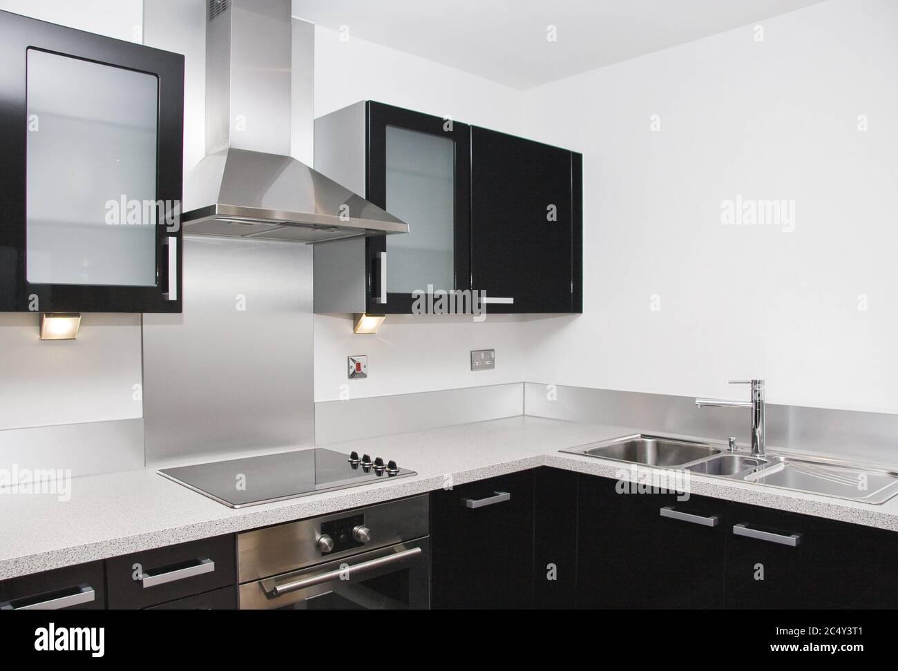contemporary kitchen with a black piano finish and granite worktop ...