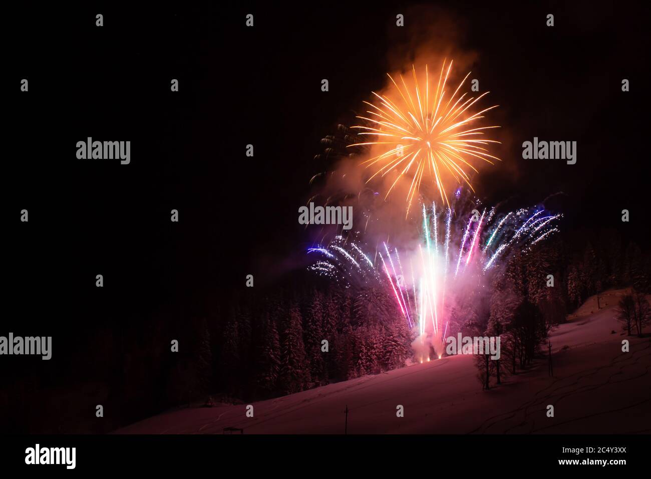 Winter night in the snowy alps with firework celebrations Stock Photo ...