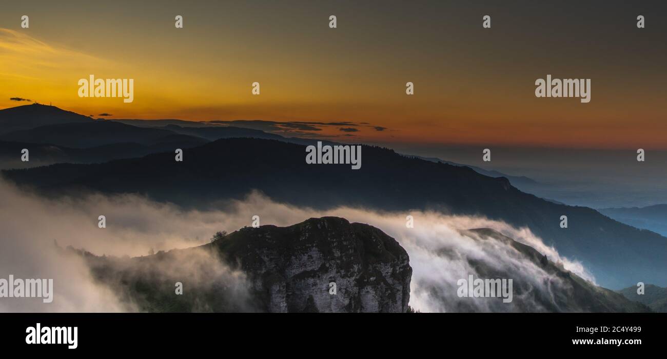 Mountain and soft clouds during a colorful dawn Stock Photo - Alamy
