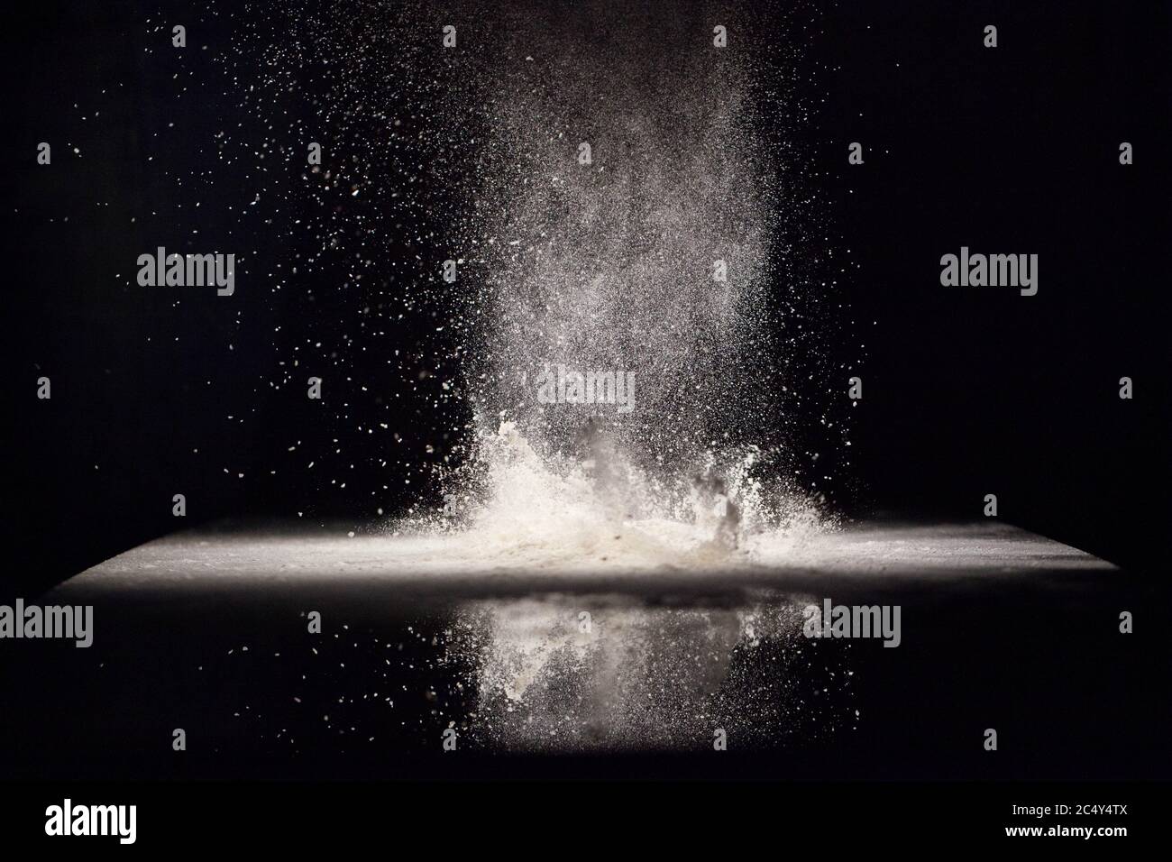The loose flour lies on the black background Stock Photo - Alamy
