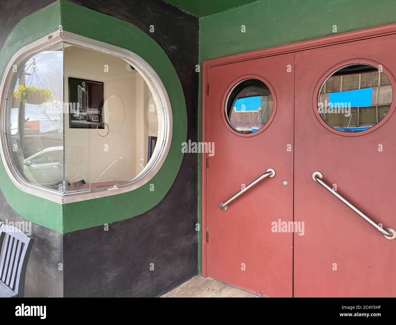 a vintage theater ticket window and doors painted red and green at an ...